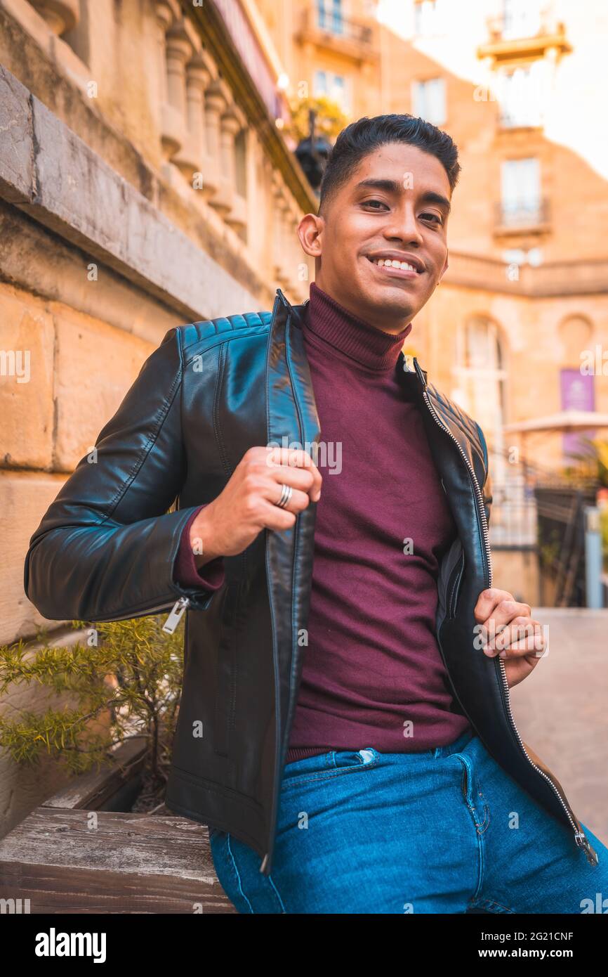 Handsome Hispanic guy posing in a leather jacket outdoor Stock Photo ...