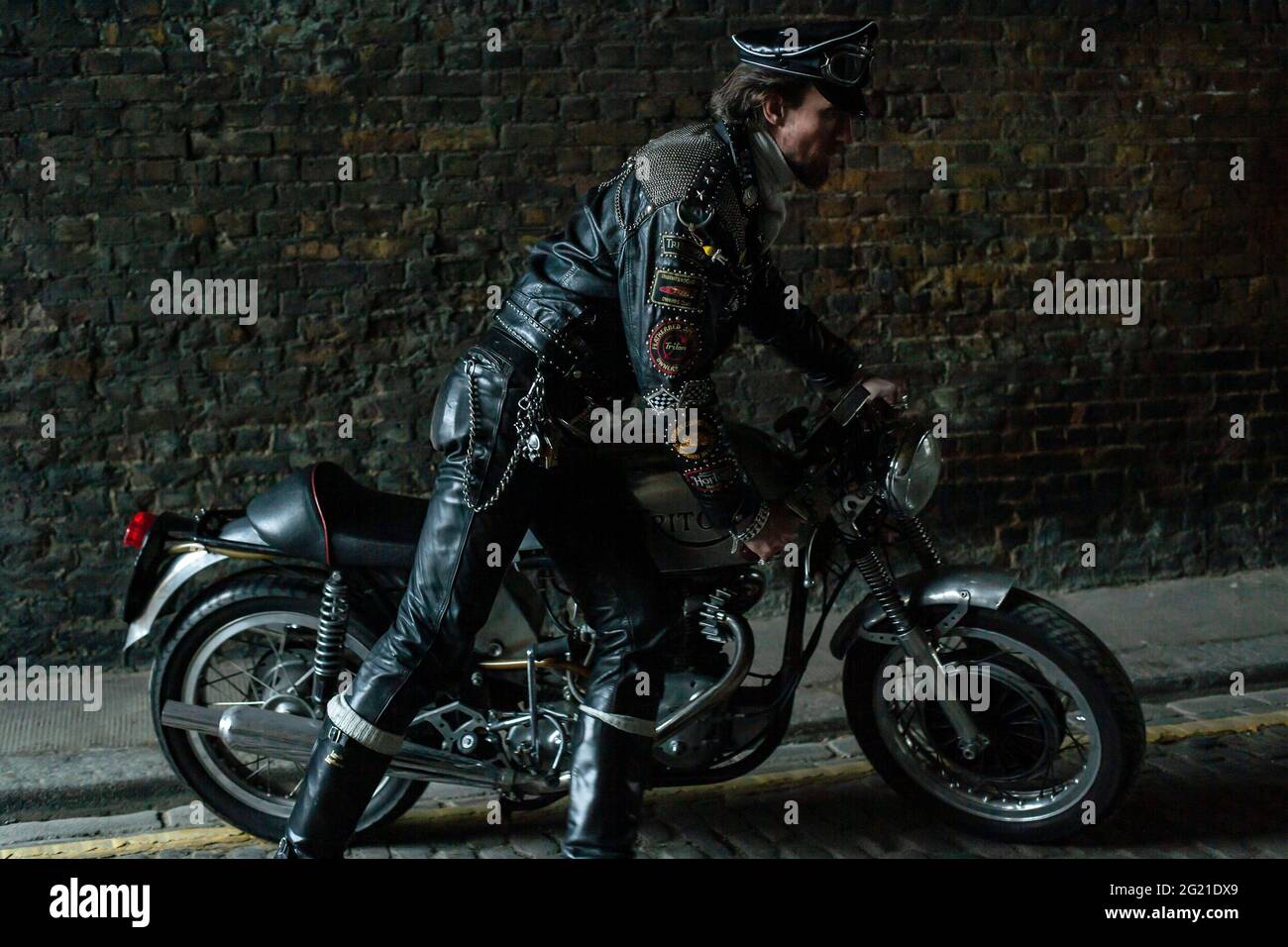 Rocker in cafe racer gear wearing black leather jacket covered in studs ...