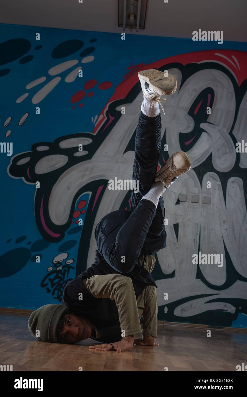 Modern rapper dancing in garage. Urban lifestyle, hip hop Stock Photo ...