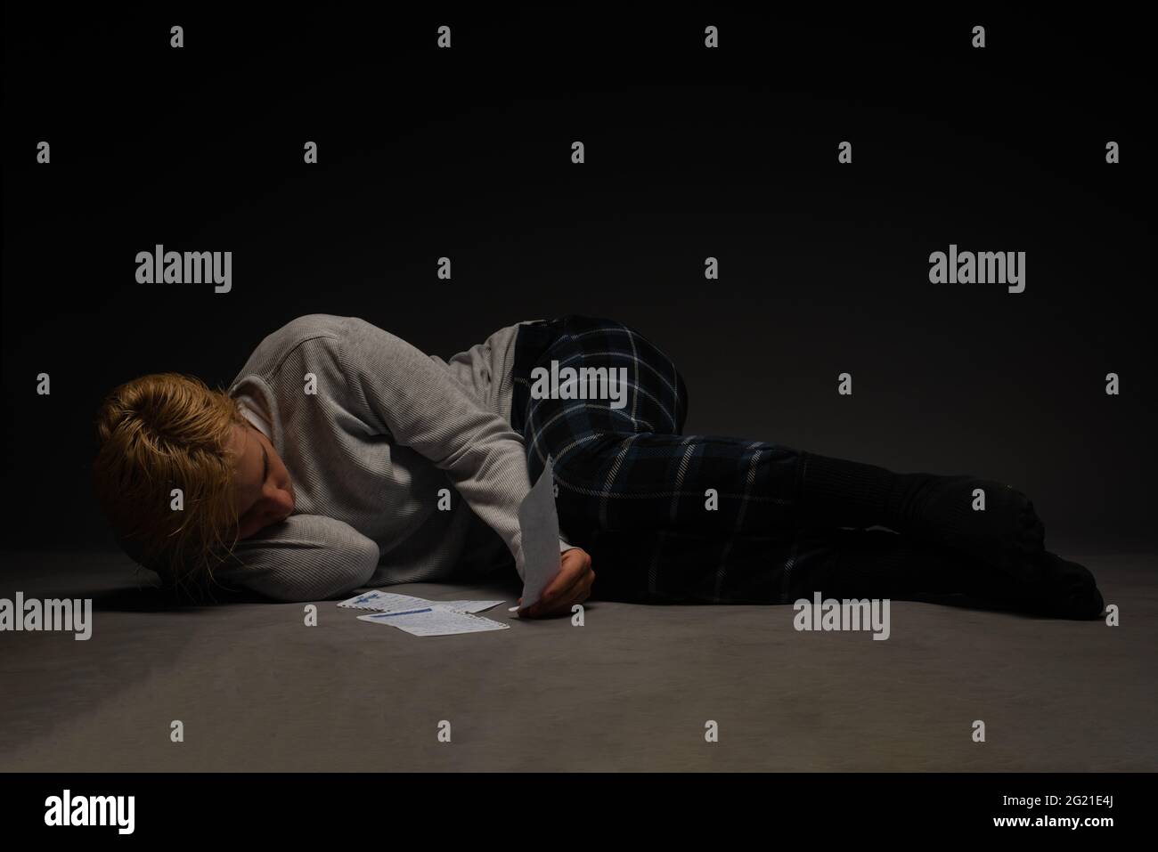 Blonde boy is suffering while reading the letters from his love that ...