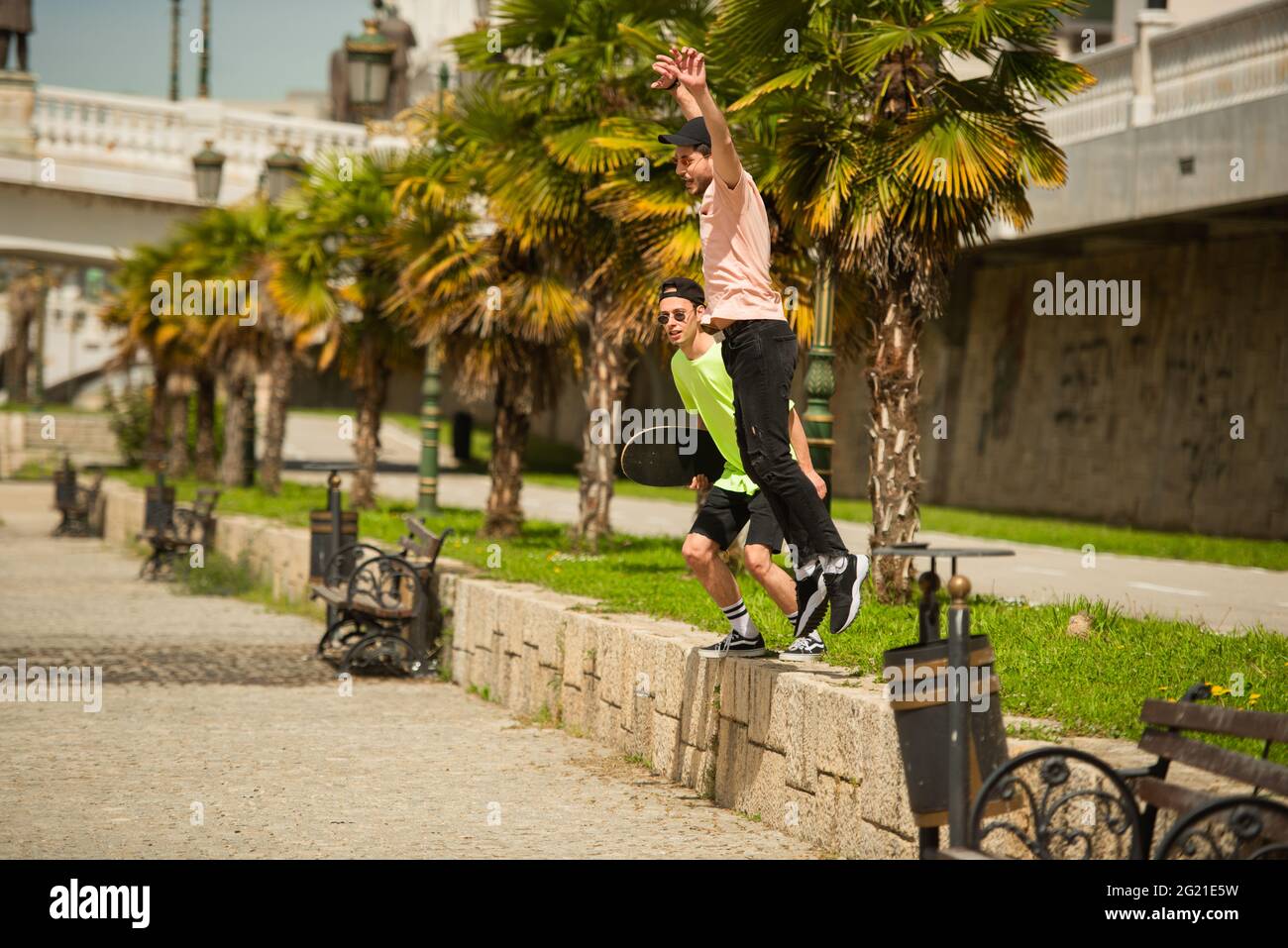 Two fit male friends are acting crazy while jumping together Stock ...