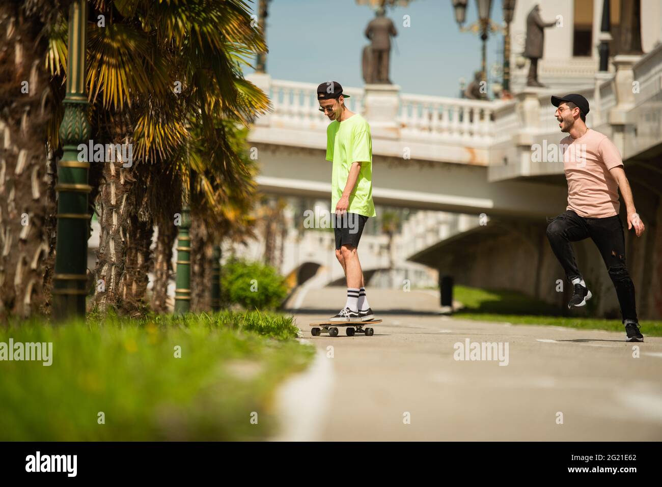 Two fit and handsome male friends are having a crazy fun time together ...