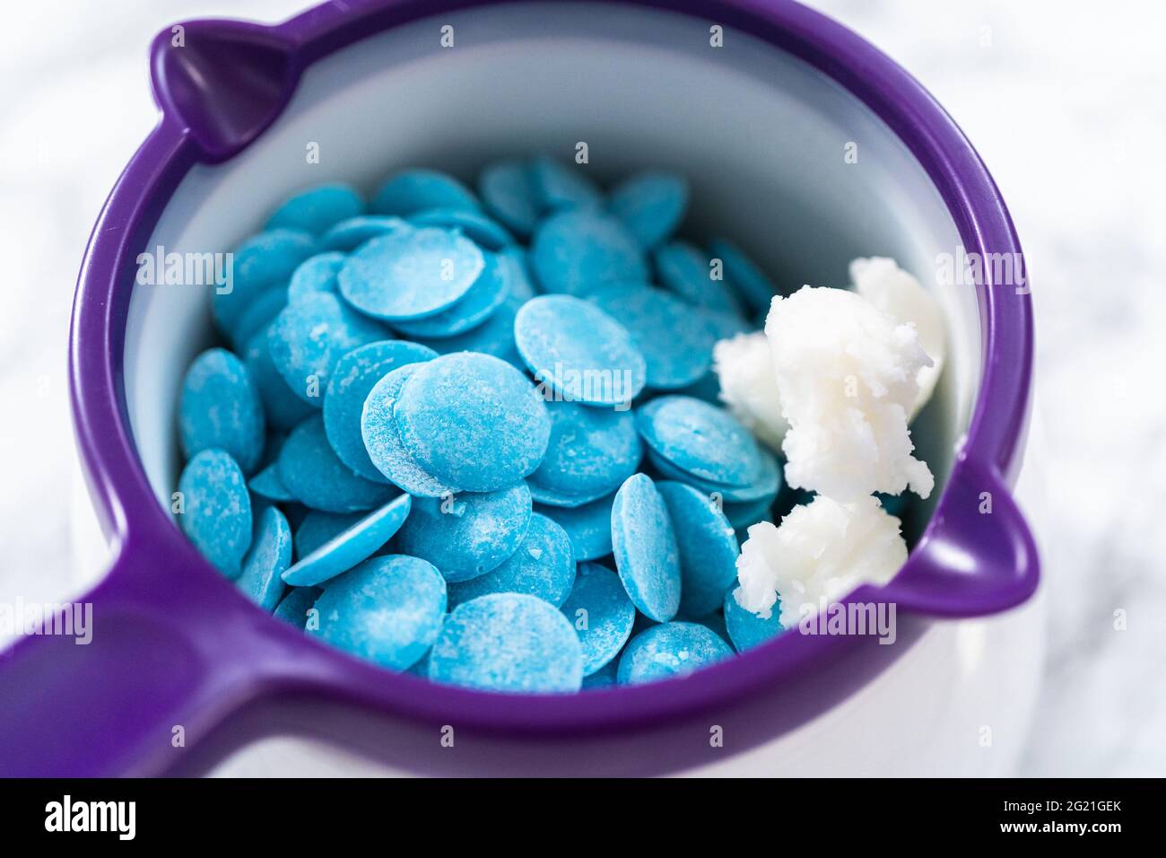Melting chocolate in a cand melting pot to prepare mermaid chocolate ...