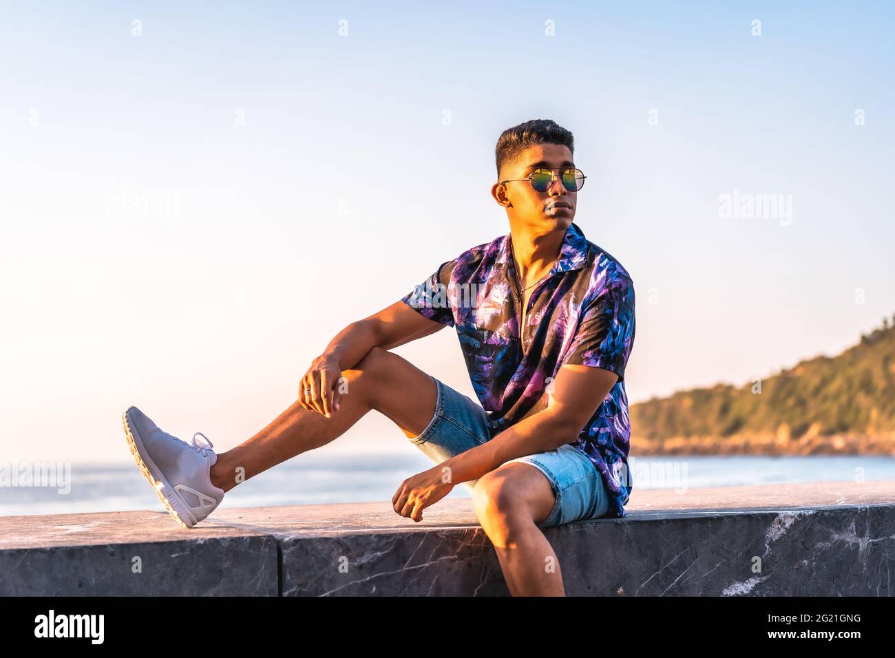 Hispanic male enjoying summer at the beac Stock Photo - Alamy