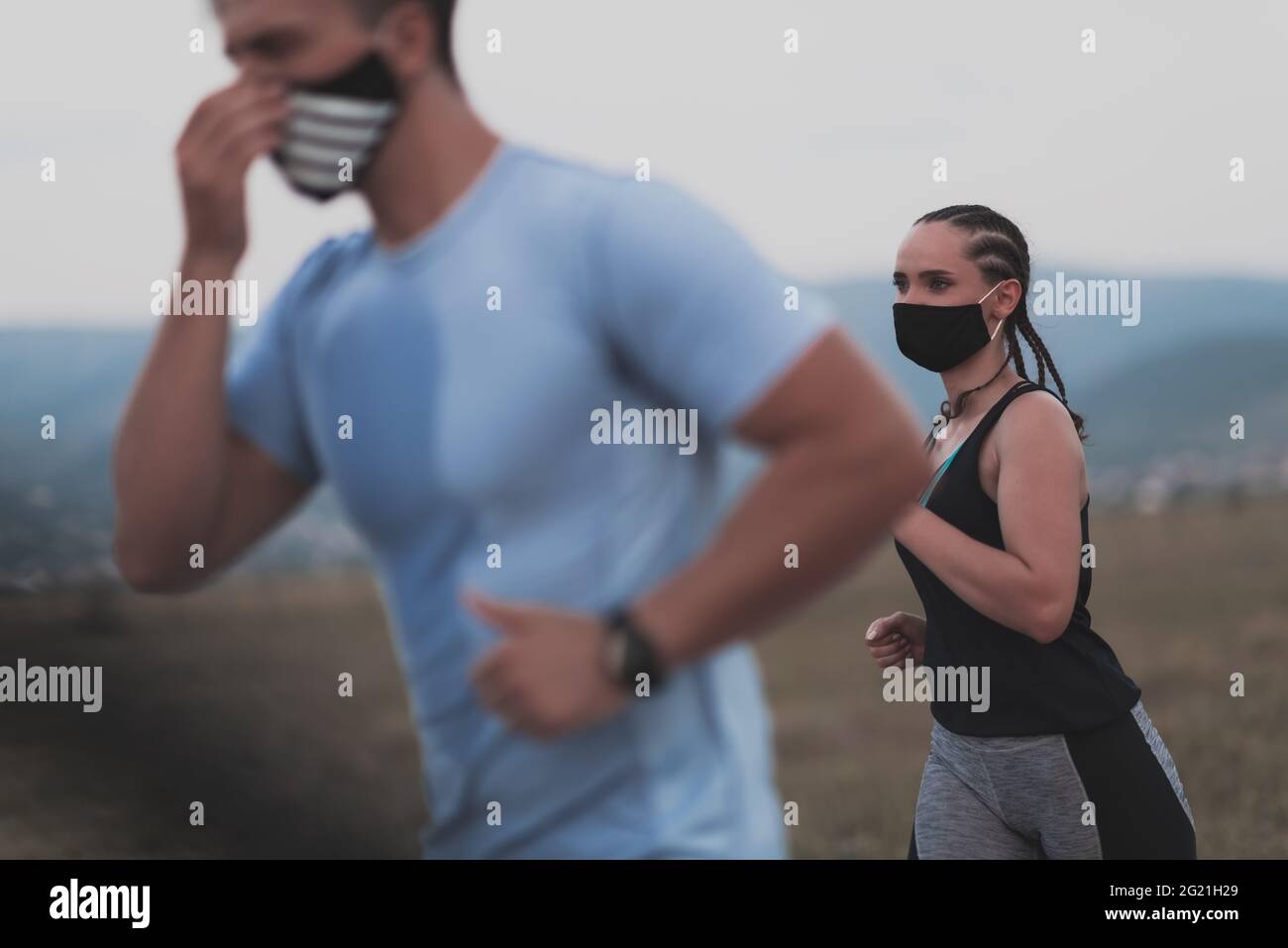 Three multiethnic women runners group wear face masks running keep ...