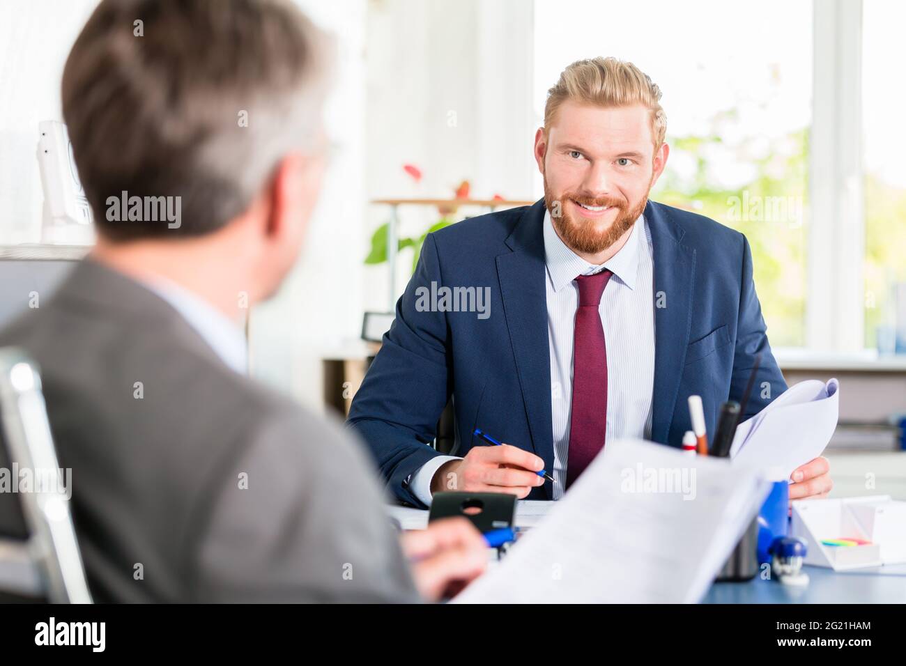 Manager signing documents at the office Stock Photo - Alamy