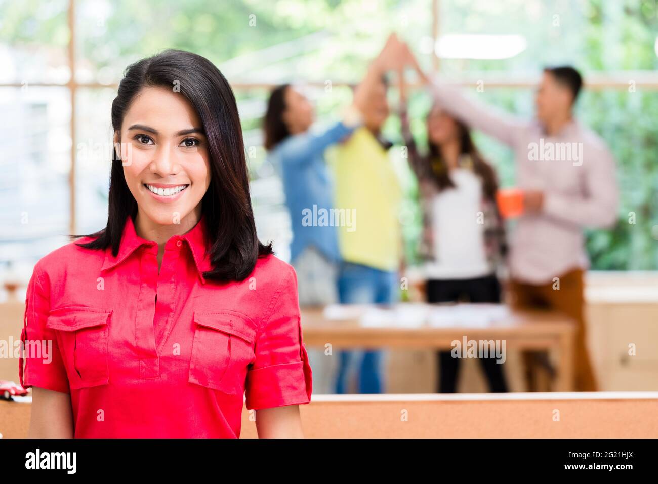 Portrait of young confident Asian employee happy to be the member of a ...