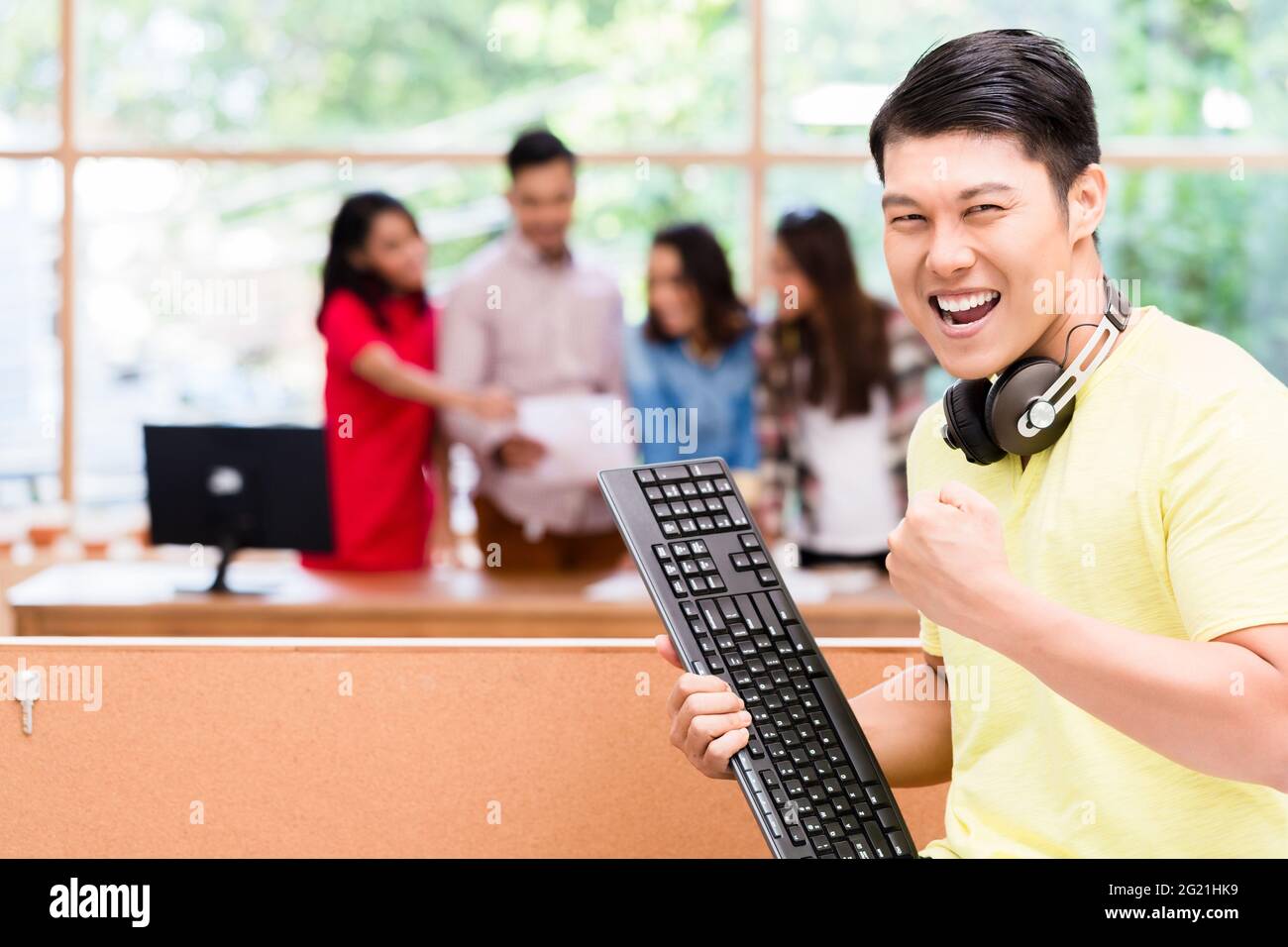 Portrait of young Chinese employee happy for his successful work on ...