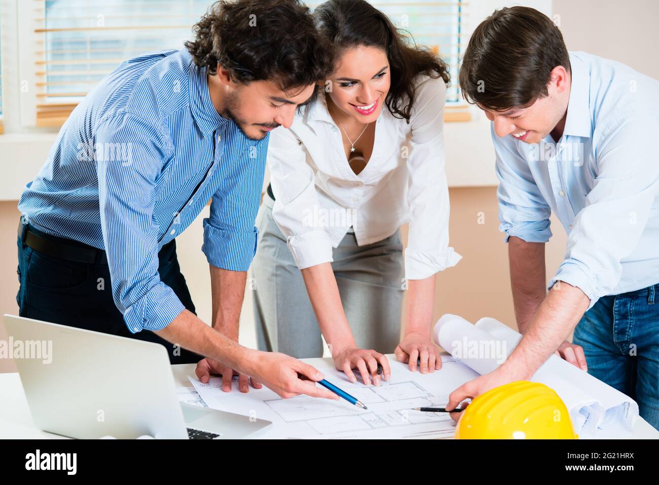 Civil engineers and architects talking about ground plot for building ...