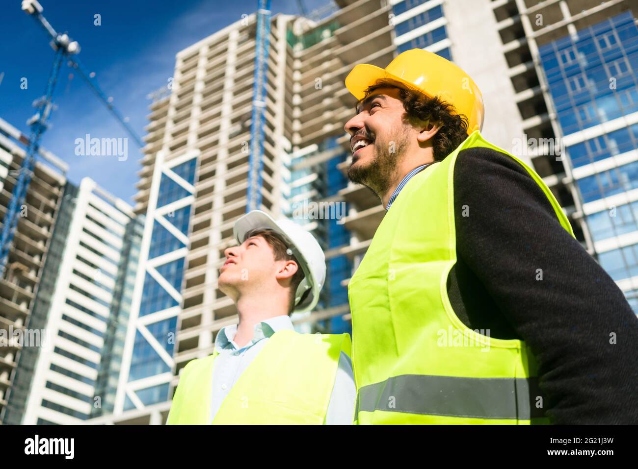 Architects or civil engineers on large construction site giving ...