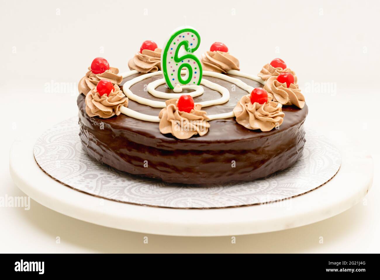 Birthday chocolate cake with candle in the form of number Six. Homemade ...