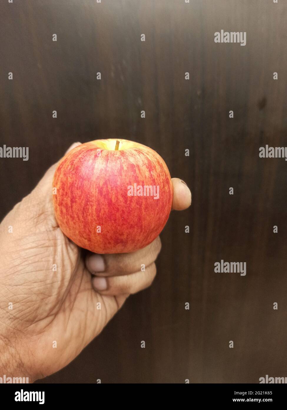 A Man holding an Apple Stock Photo - Alamy