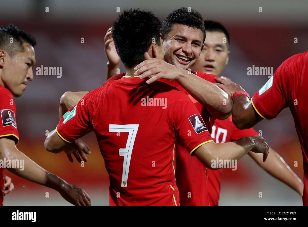 Sharjah. 8th June, 2021. Wu Lei (2nd L) of China celebrates scoring ...