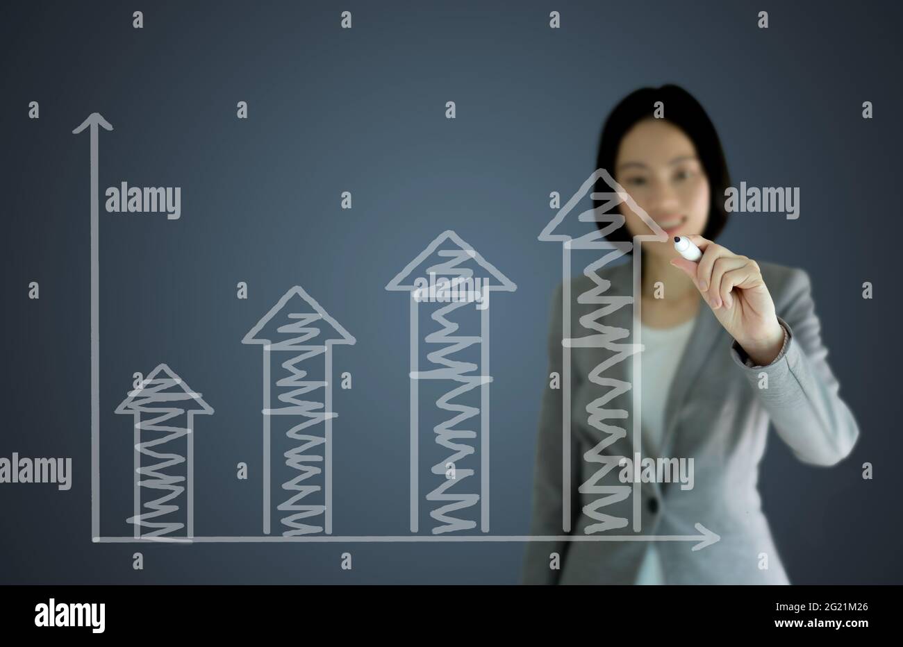 Business woman writing about on graph Stock Photo - Alamy