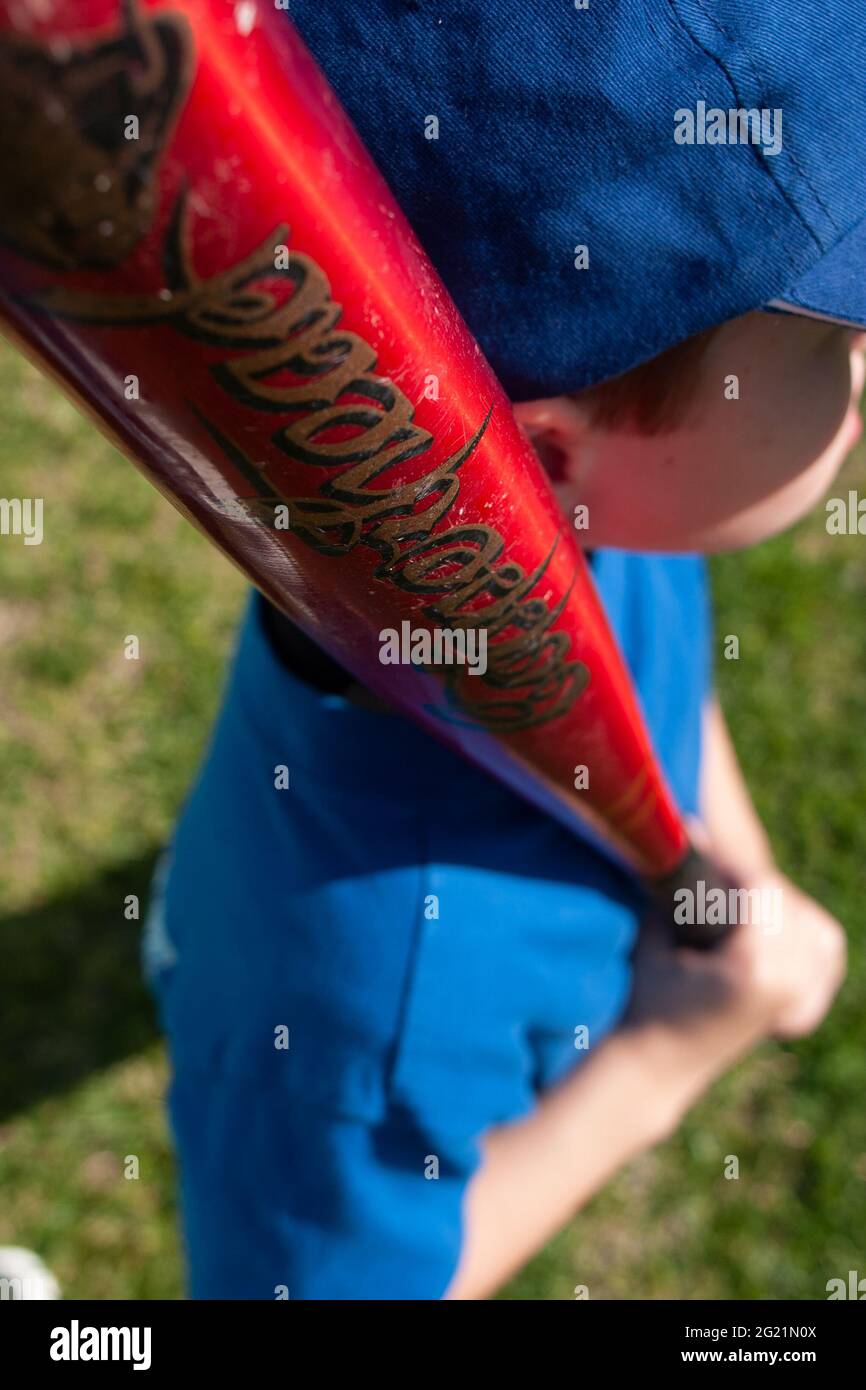 Child holding a baseball bat in a field Stock Photo - Alamy
