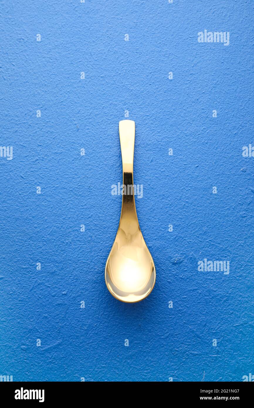 Golden spoon blue handle hi-res stock photography and images - Alamy