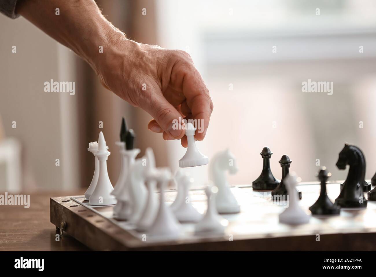 Man playing chess at home Stock Photo - Alamy
