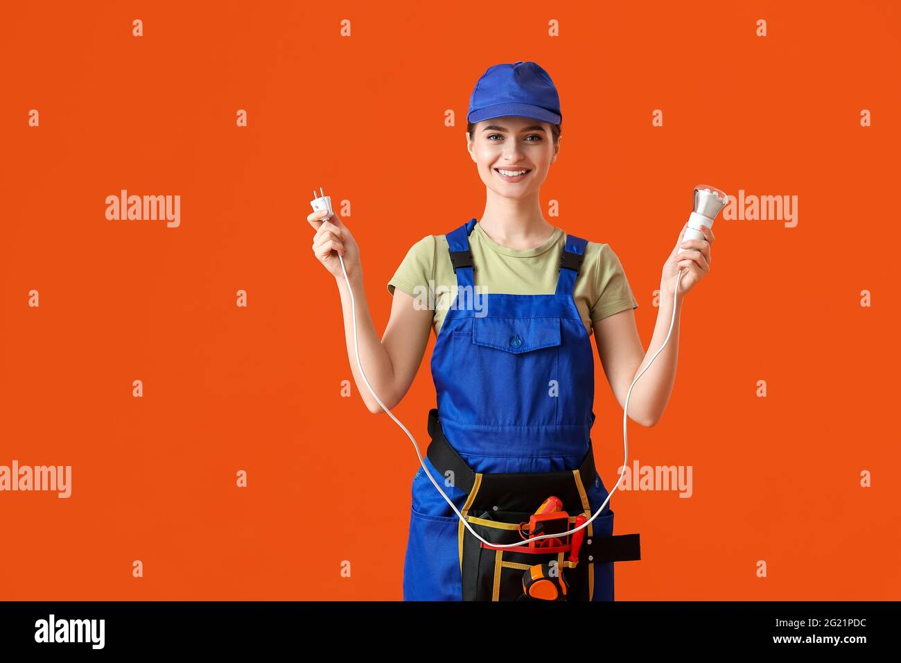Beautiful female electrician with light bulb on color background Stock ...