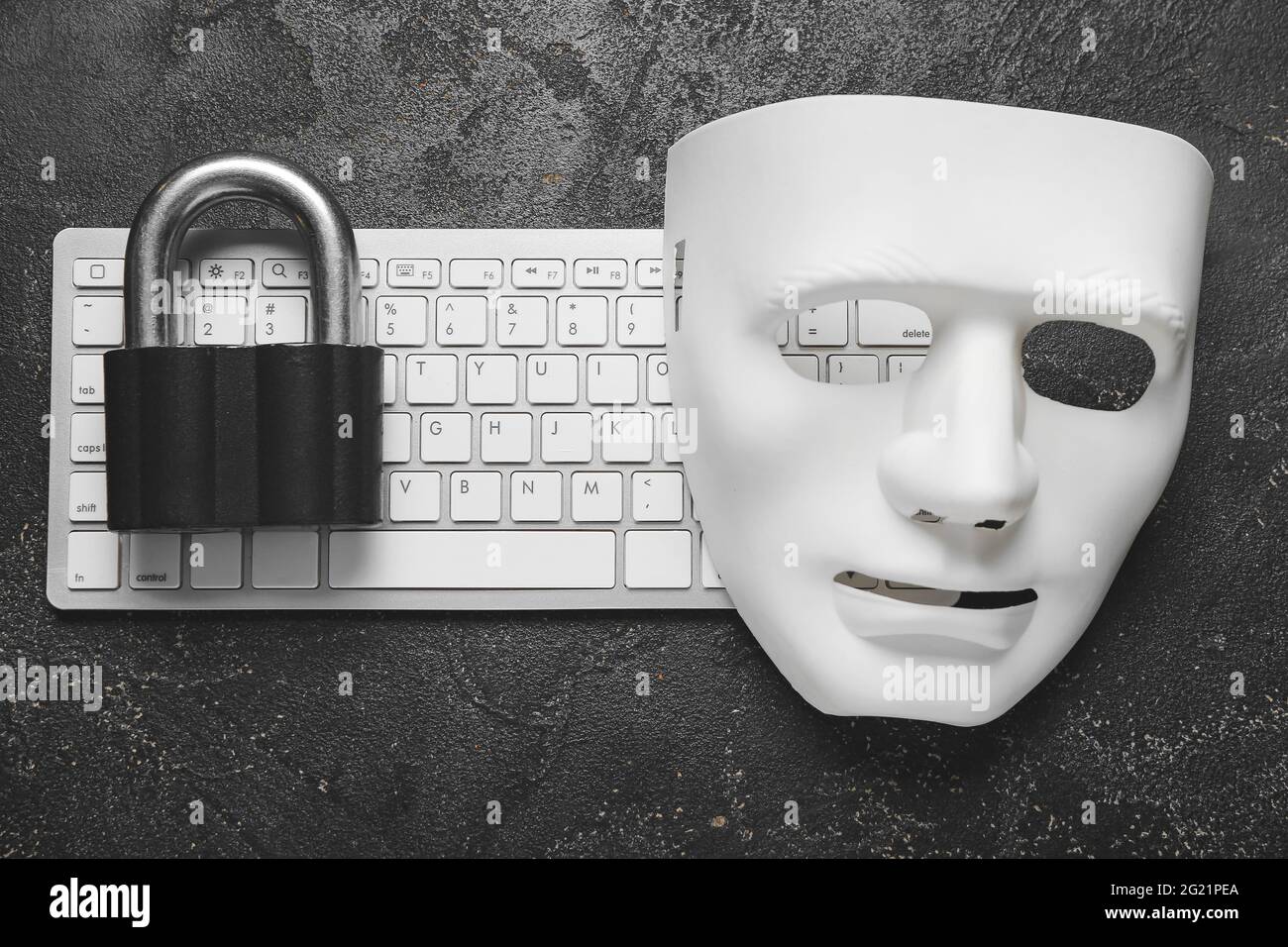 PC keyboard, mask and lock on dark background. Hacking concept Stock ...