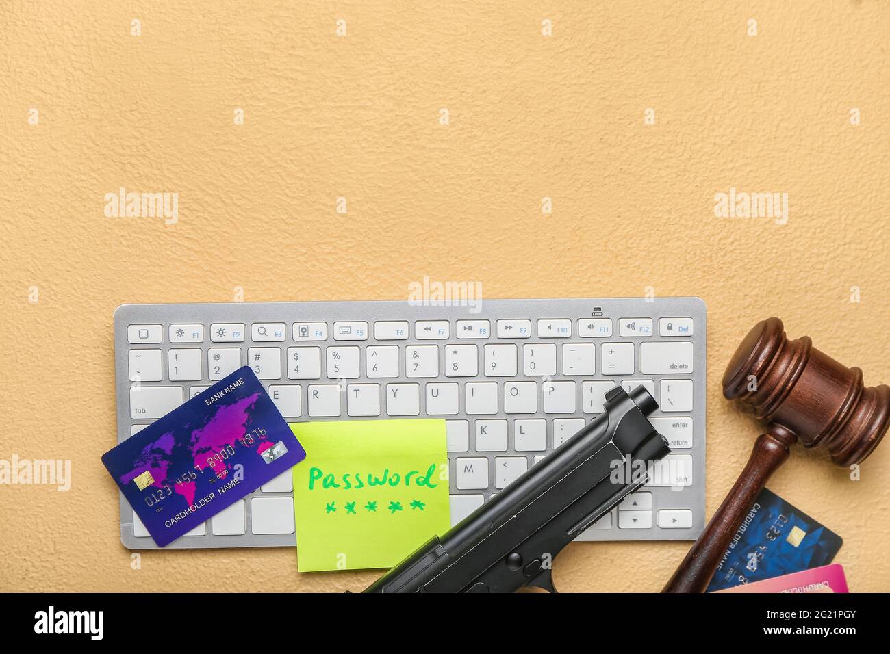 PC keyboard, credit cards, judge gavel and gun on color background ...
