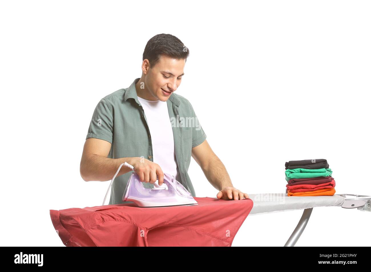 Handsome young man ironing clothes on white background Stock Photo - Alamy