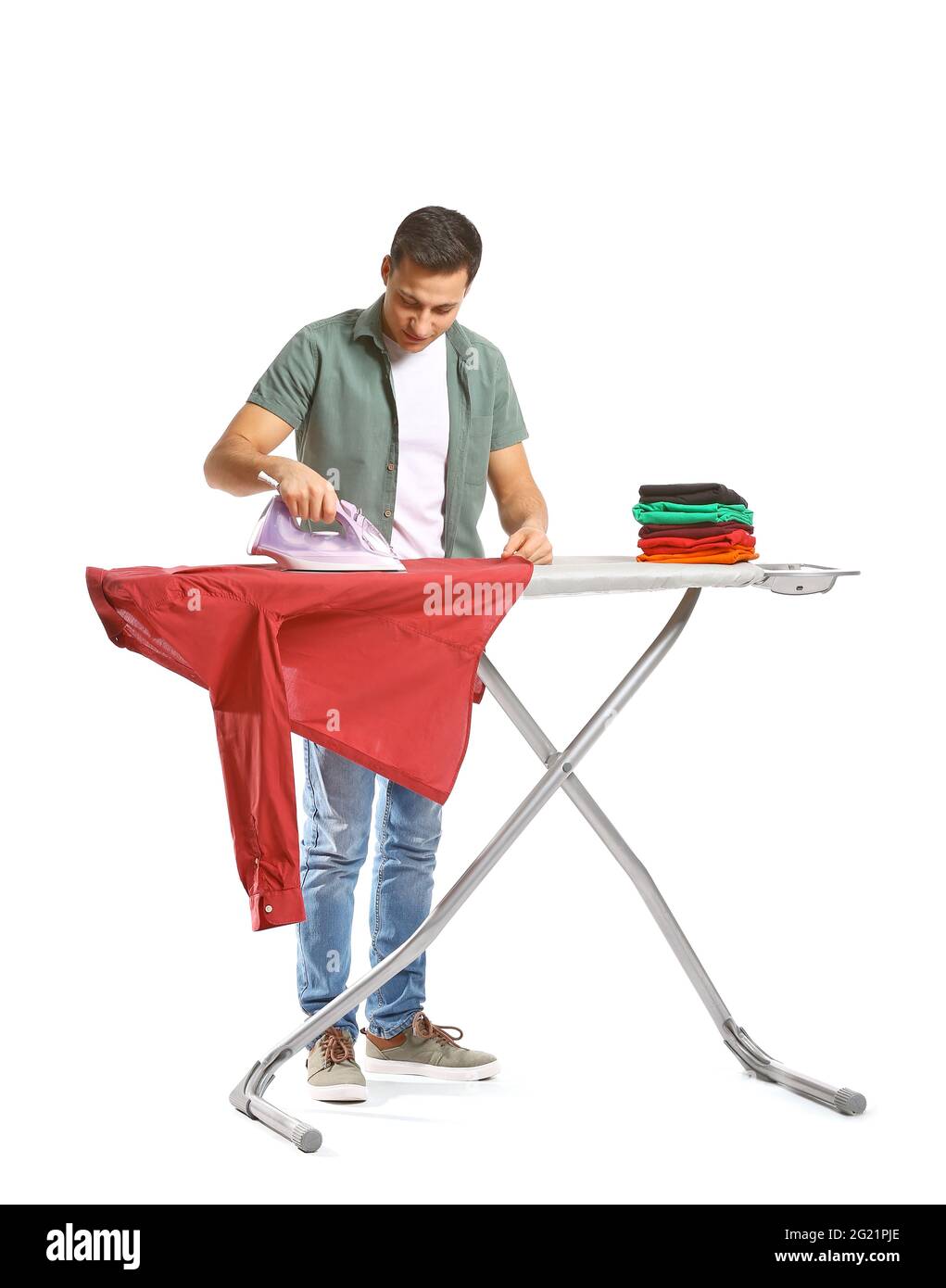 Handsome young man ironing clothes on white background Stock Photo - Alamy