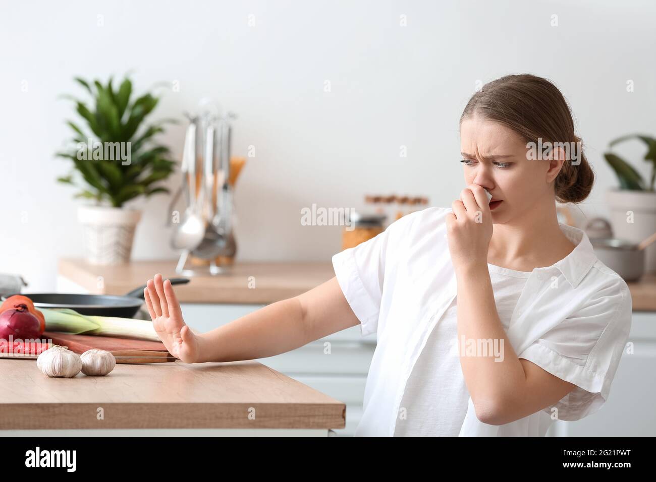 Sick young woman in kitchen hi-res stock photography and images - Alamy