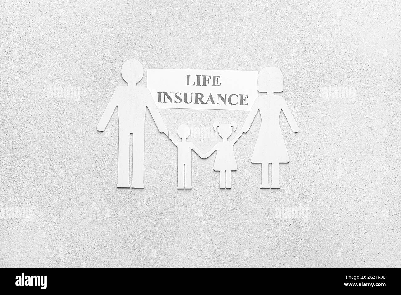 Family figures with text LIFE INSURANCE on light background Stock Photo ...