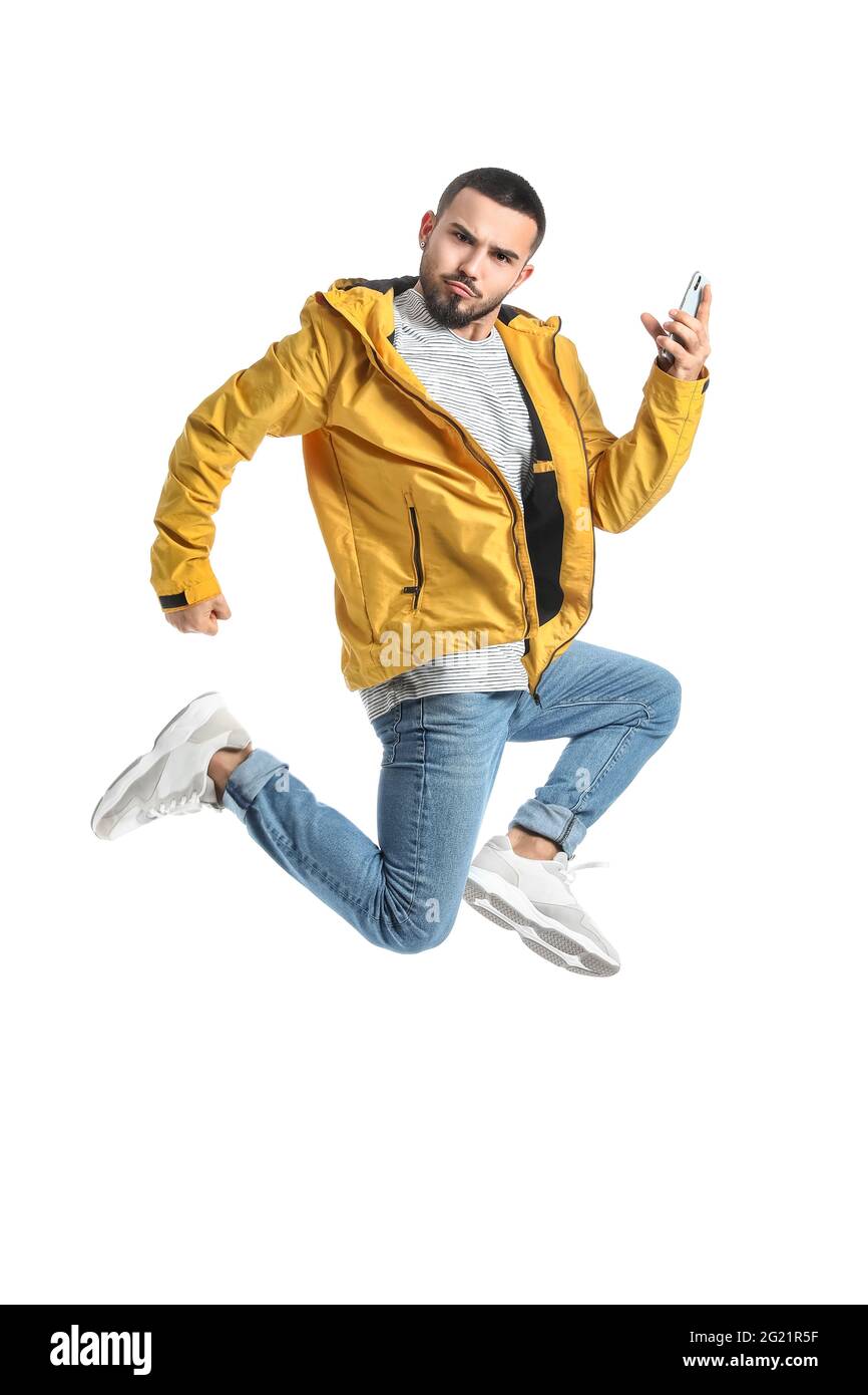Young man jumping mobile phone Cut Out Stock Images & Pictures - Alamy
