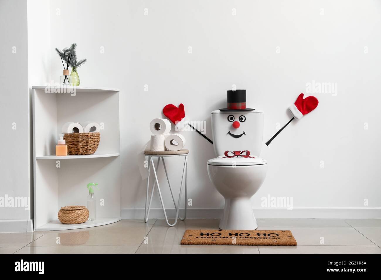 Toilet decorated as funny snowman near white wall Stock Photo - Alamy