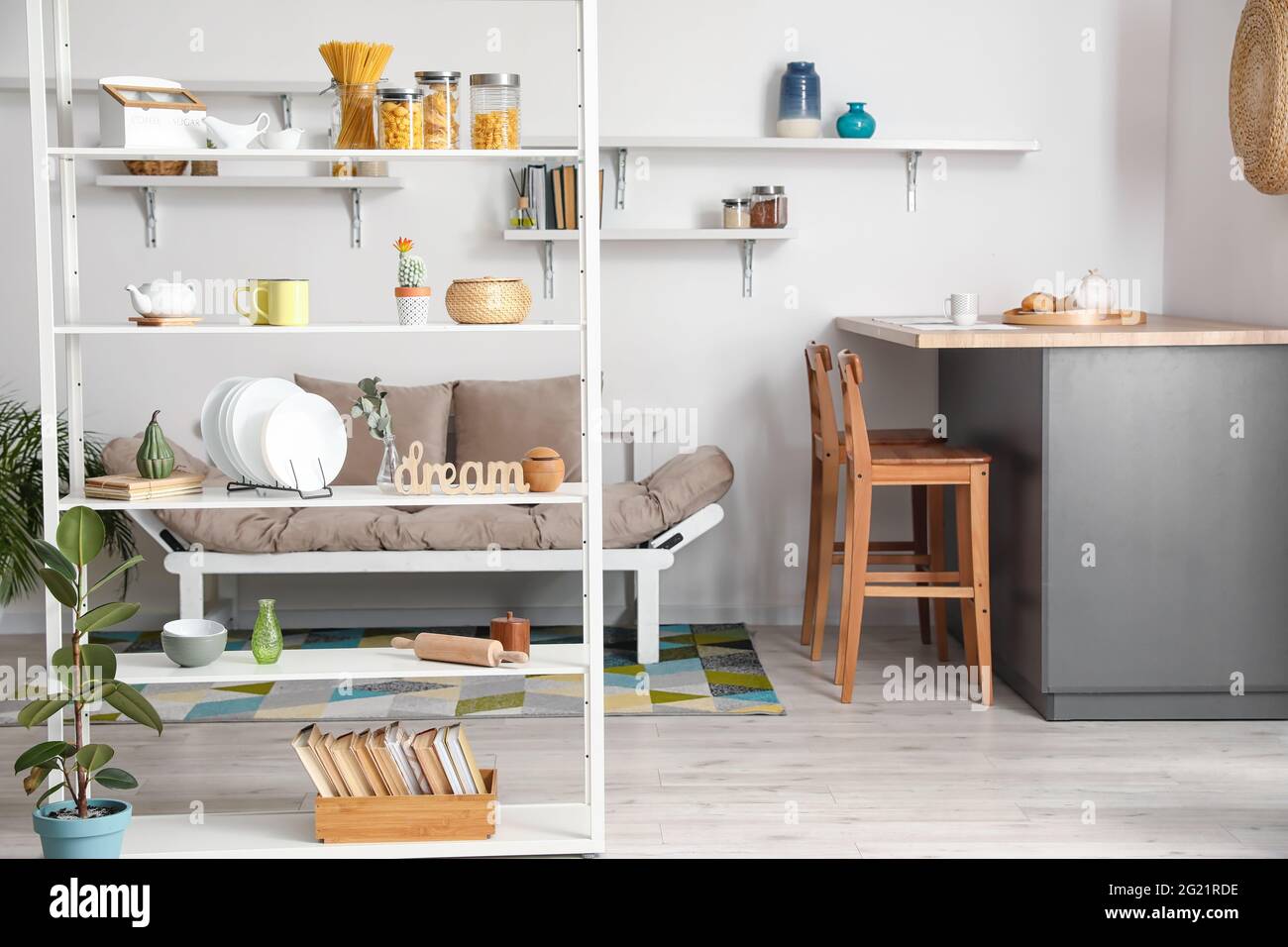 Interior of modern kitchen with shelf unit Stock Photo - Alamy