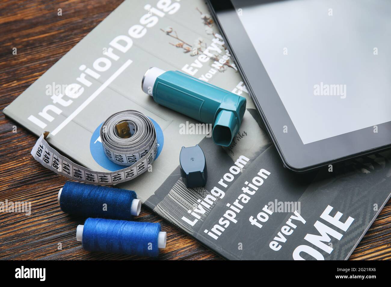 Composition with inhaler and tailor's tools on dark wooden background ...