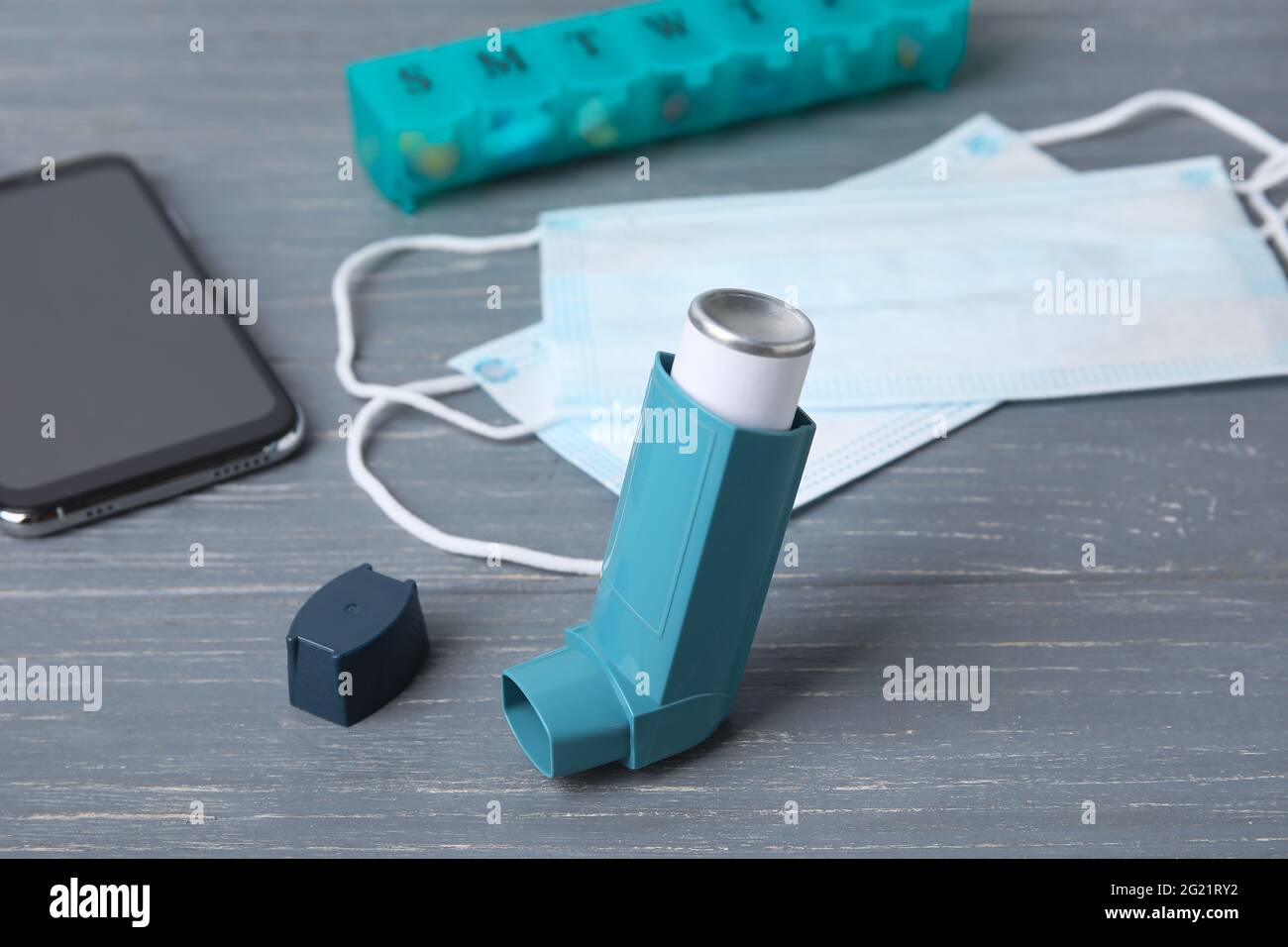 Modern inhaler and mobile phone on grey wooden background Stock Photo ...