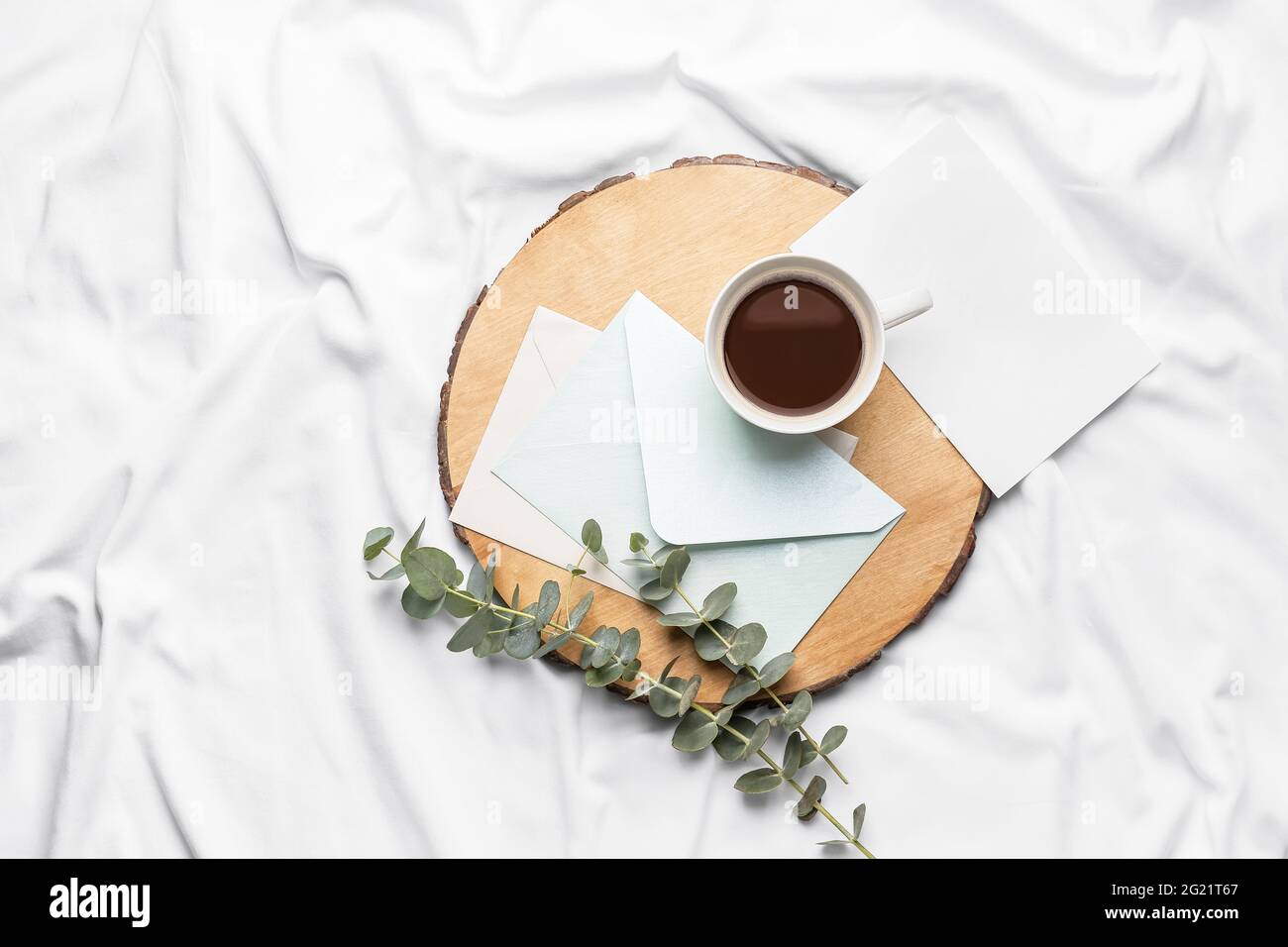 Composition with cup of coffee and envelopes on bed Stock Photo - Alamy
