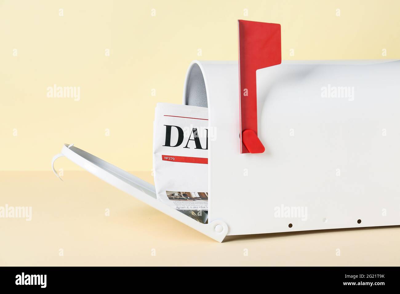 Mail box with newspaper on color background Stock Photo - Alamy