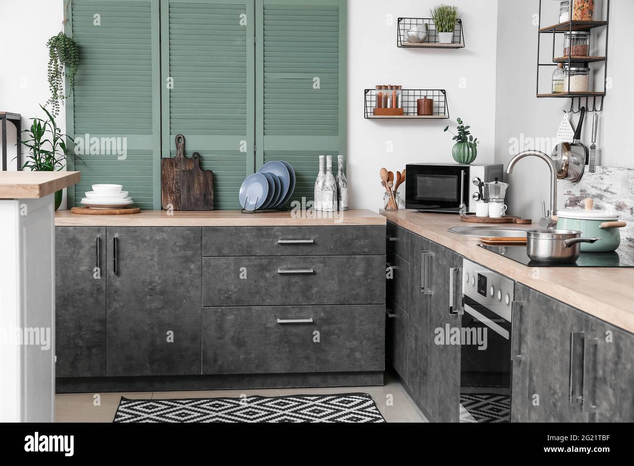 Cooking utensils and products on table in interior of modern kitchen ...