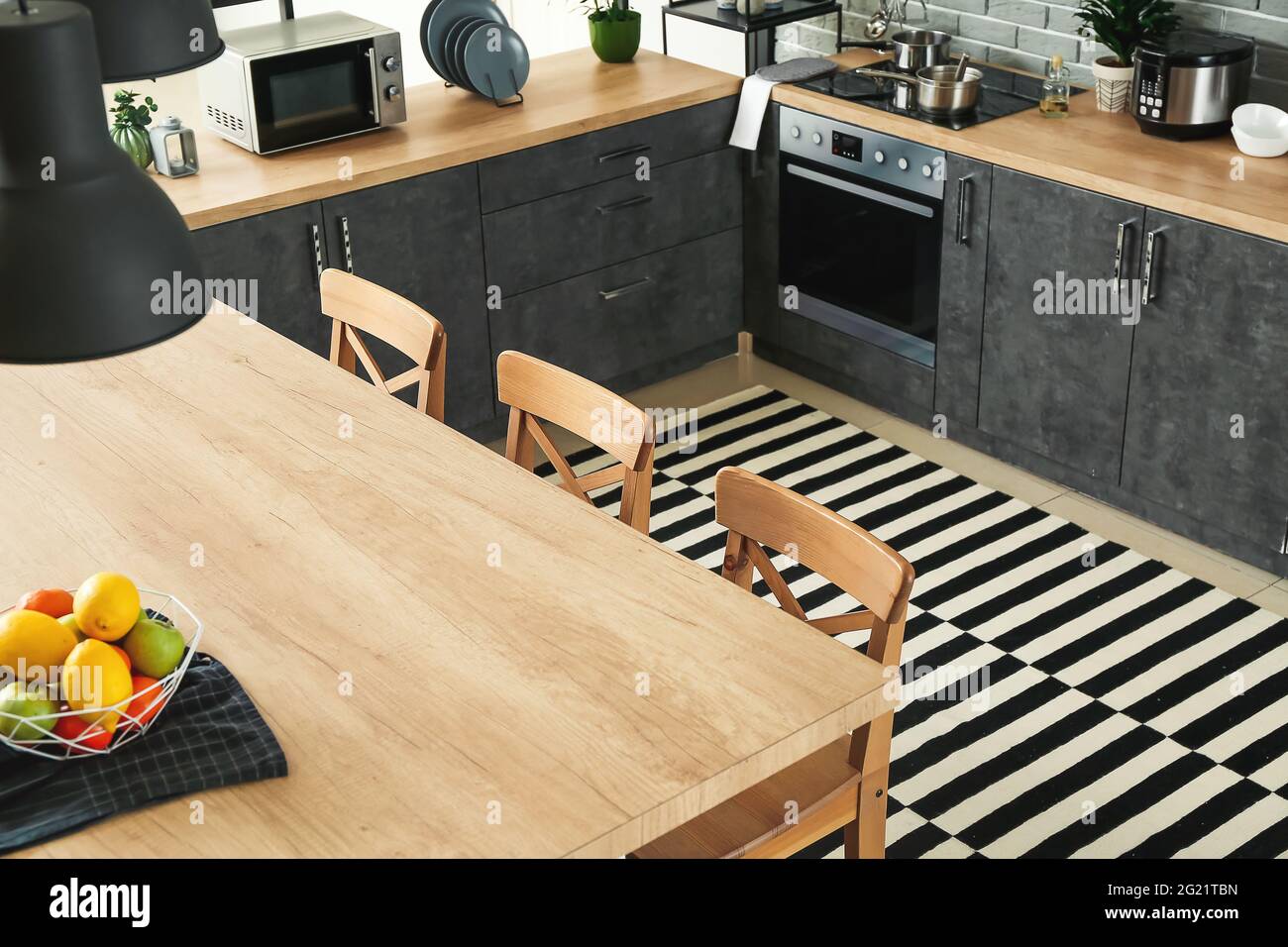 Dining table in interior of modern kitchen Stock Photo - Alamy