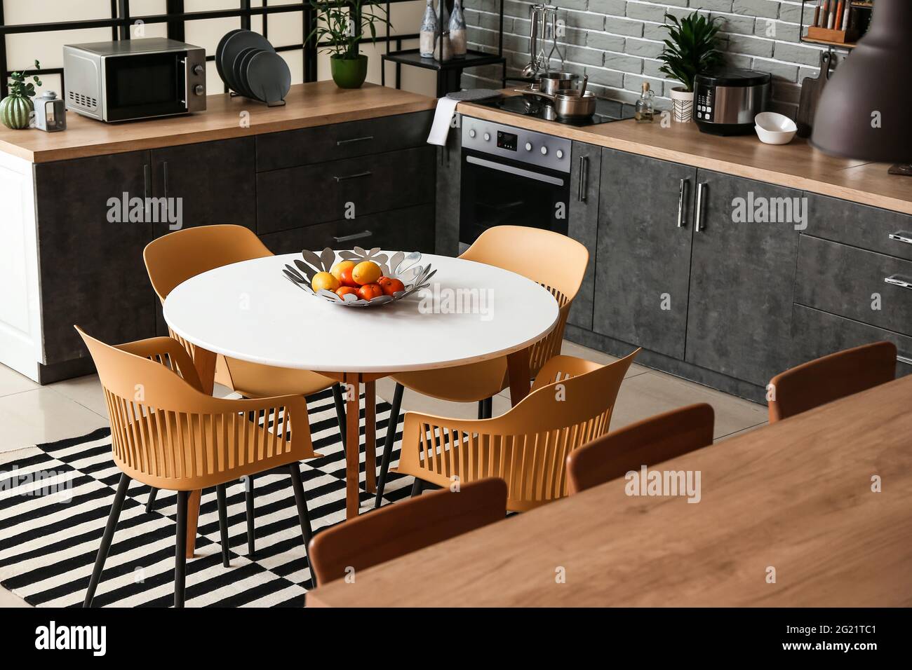 Interior of stylish modern kitchen with dining table Stock Photo - Alamy