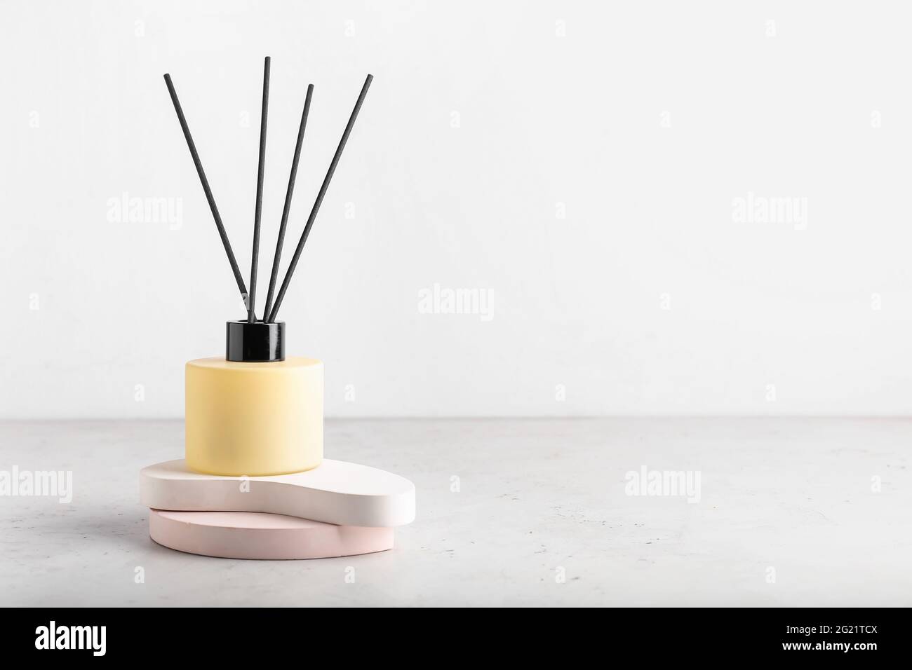 Reed diffuser on table against white background Stock Photo - Alamy