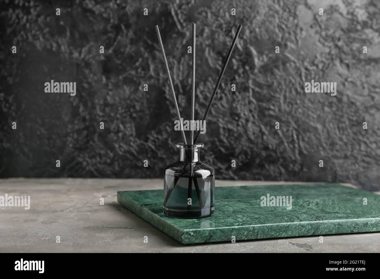 Reed diffuser on dark background Stock Photo - Alamy