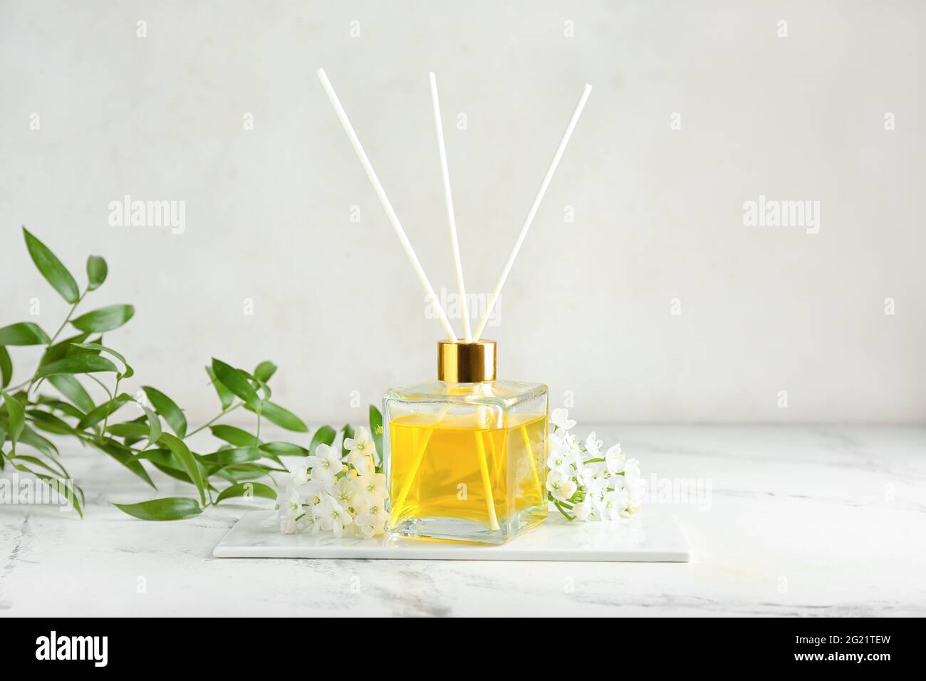 Reed diffuser with jasmine on light background Stock Photo - Alamy