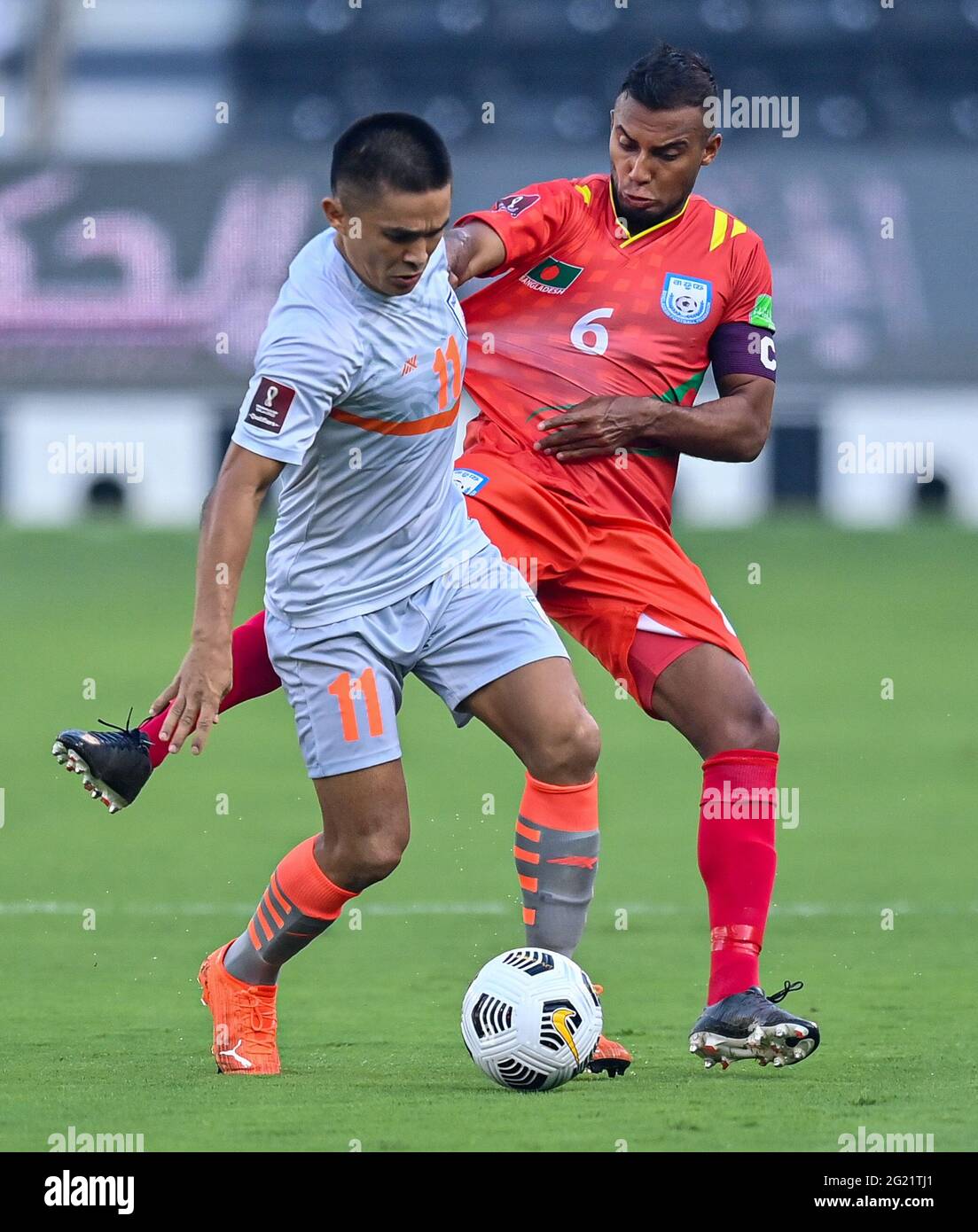 Doha, Qatar. 7th June, 2021. Sunil Chhetri (L) of India vies with Jamal Bhuyan of Bangladesh ...