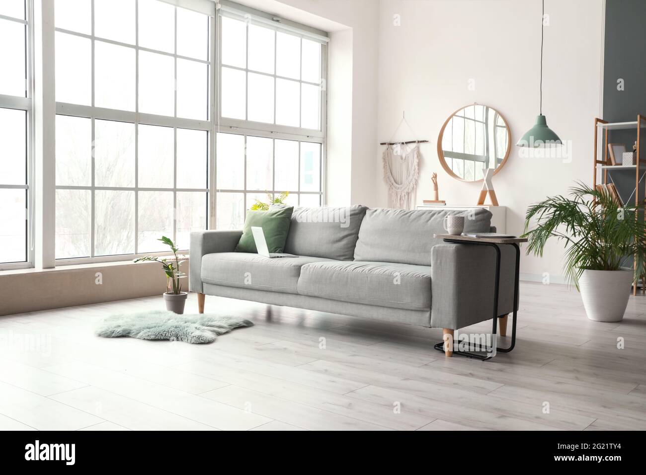Stylish interior of living room with comfortable sofa Stock Photo - Alamy