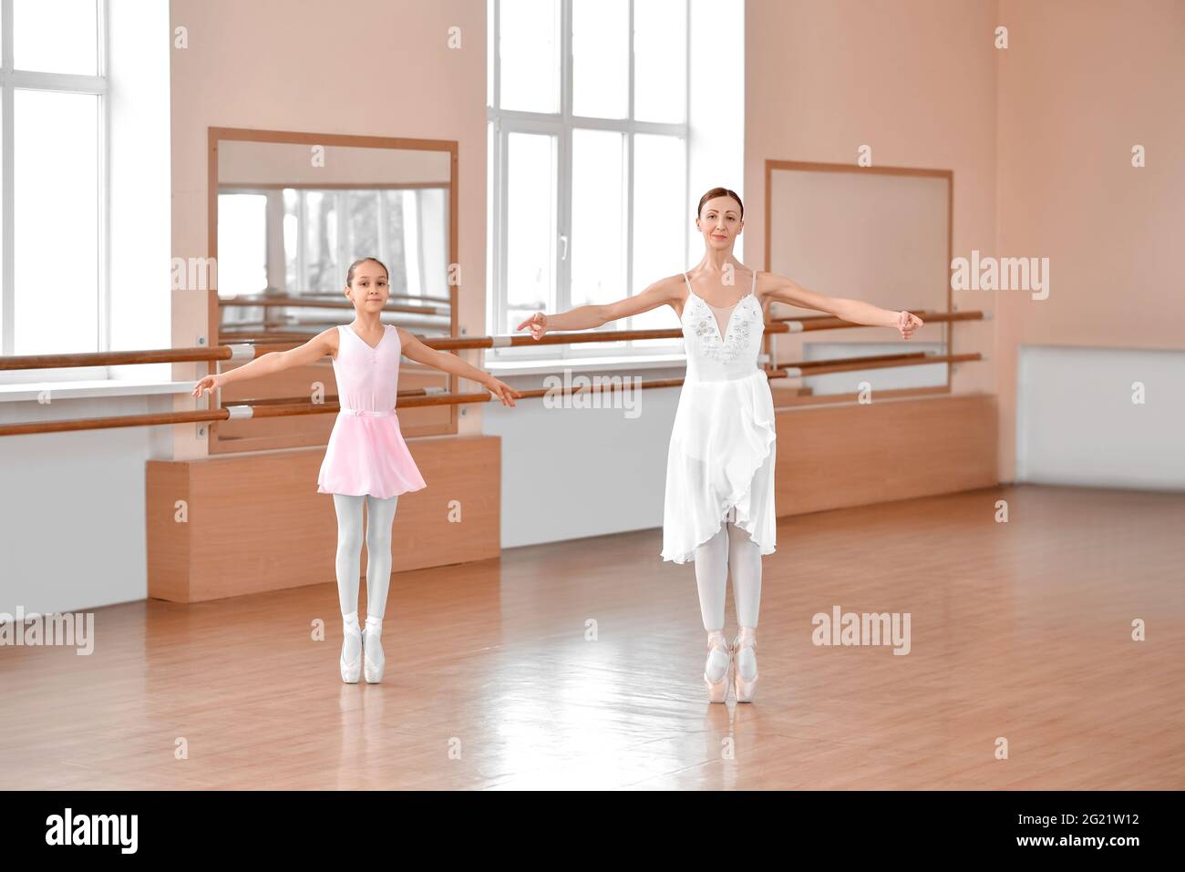 Little ballerina training with coach in dance studio Stock Photo - Alamy