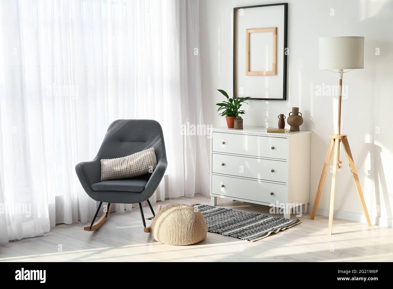 Interior of modern living room with armchair Stock Photo - Alamy