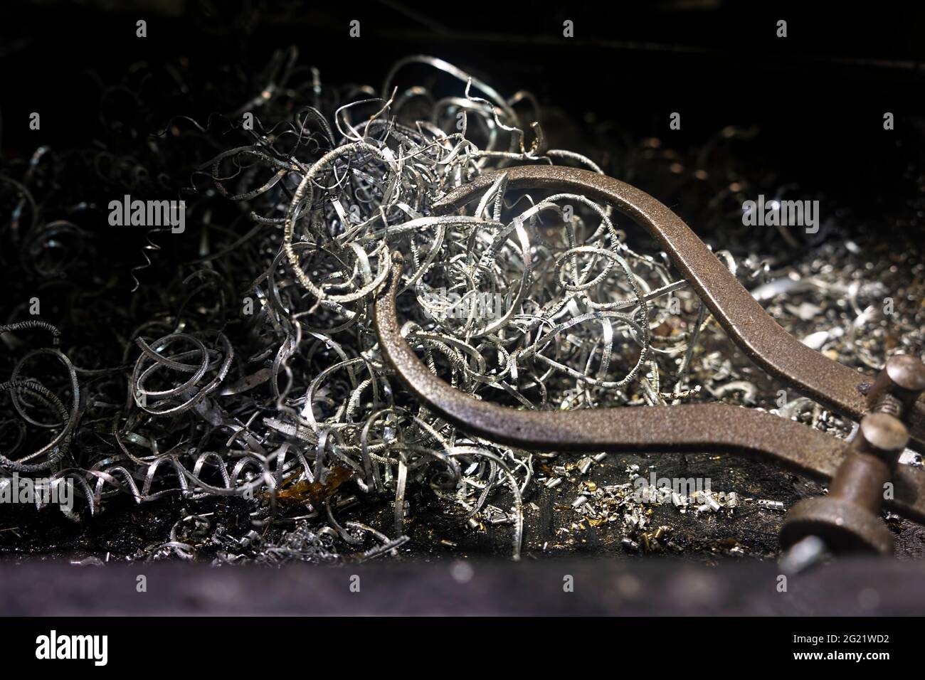Silver spirals of swarf waste from aluminium metal being turned or cut ...