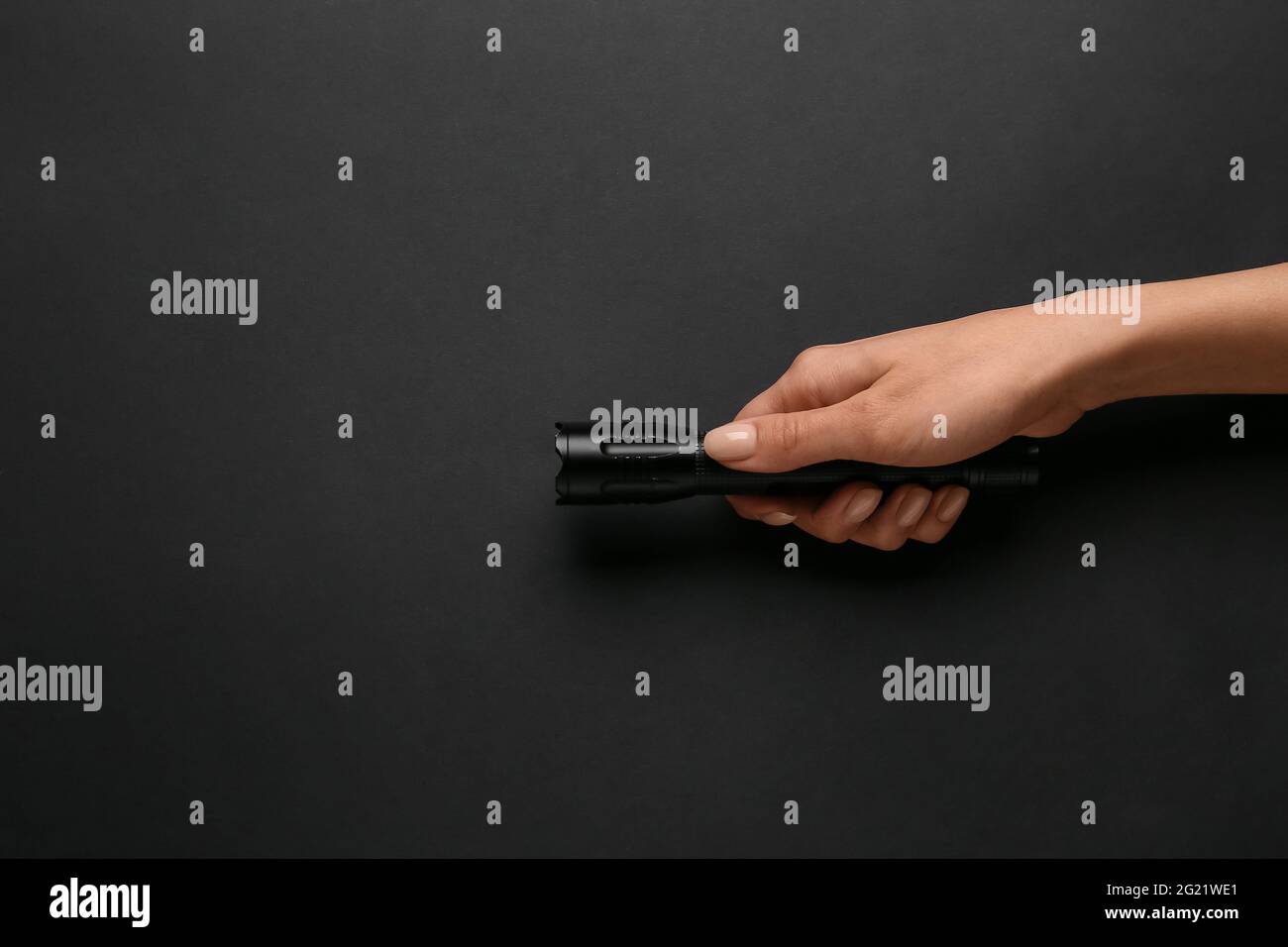 Female hand with modern flashlight on dark background Stock Photo - Alamy