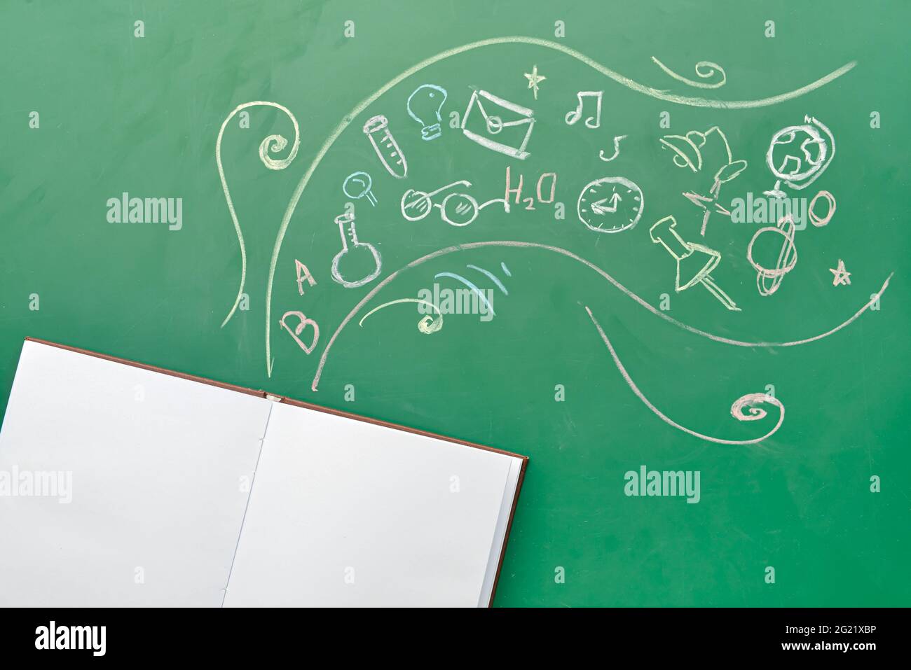 Open book and drawings on color background Stock Photo - Alamy