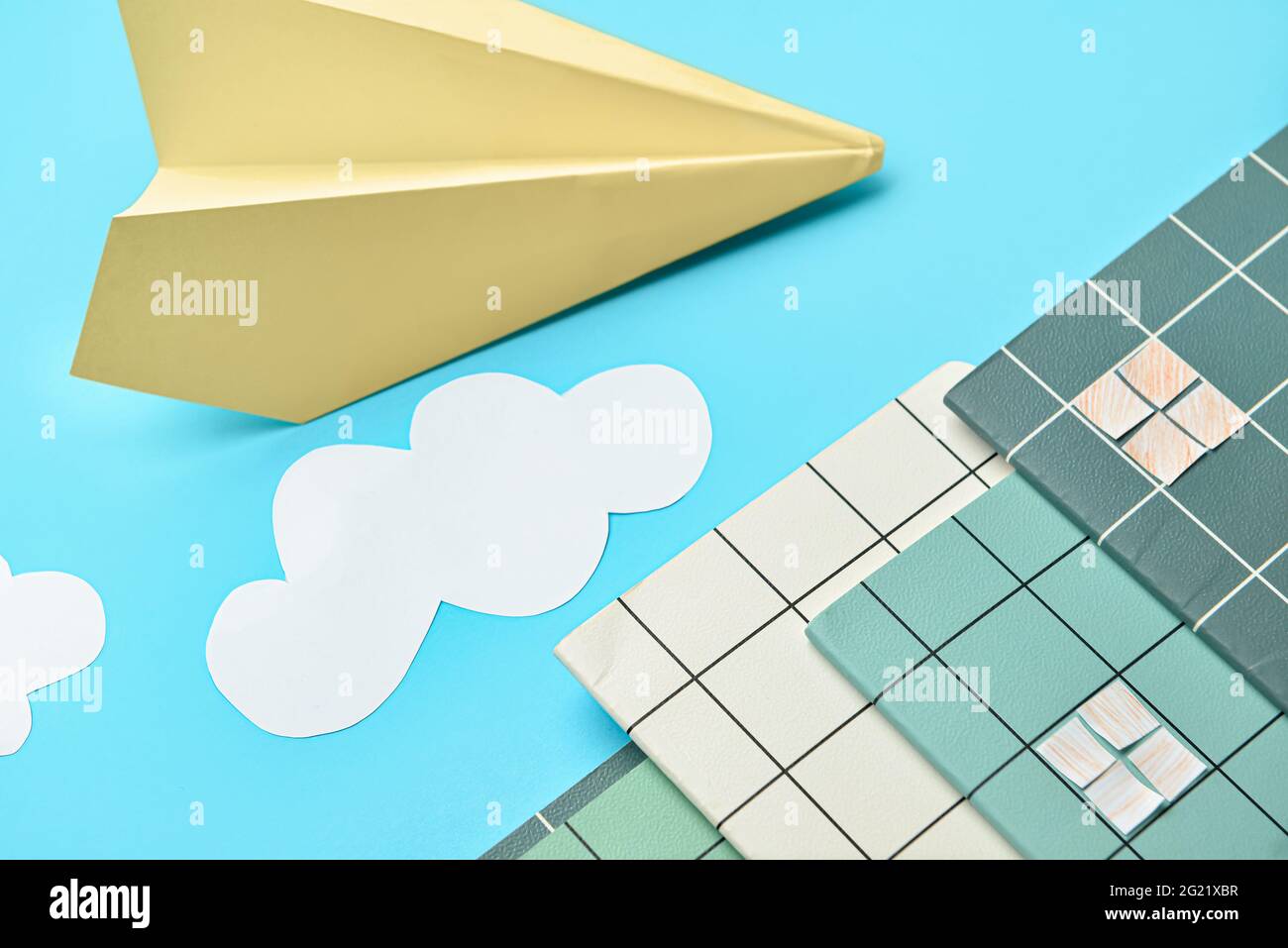 Creative composition with notebooks and paper plane on color background ...