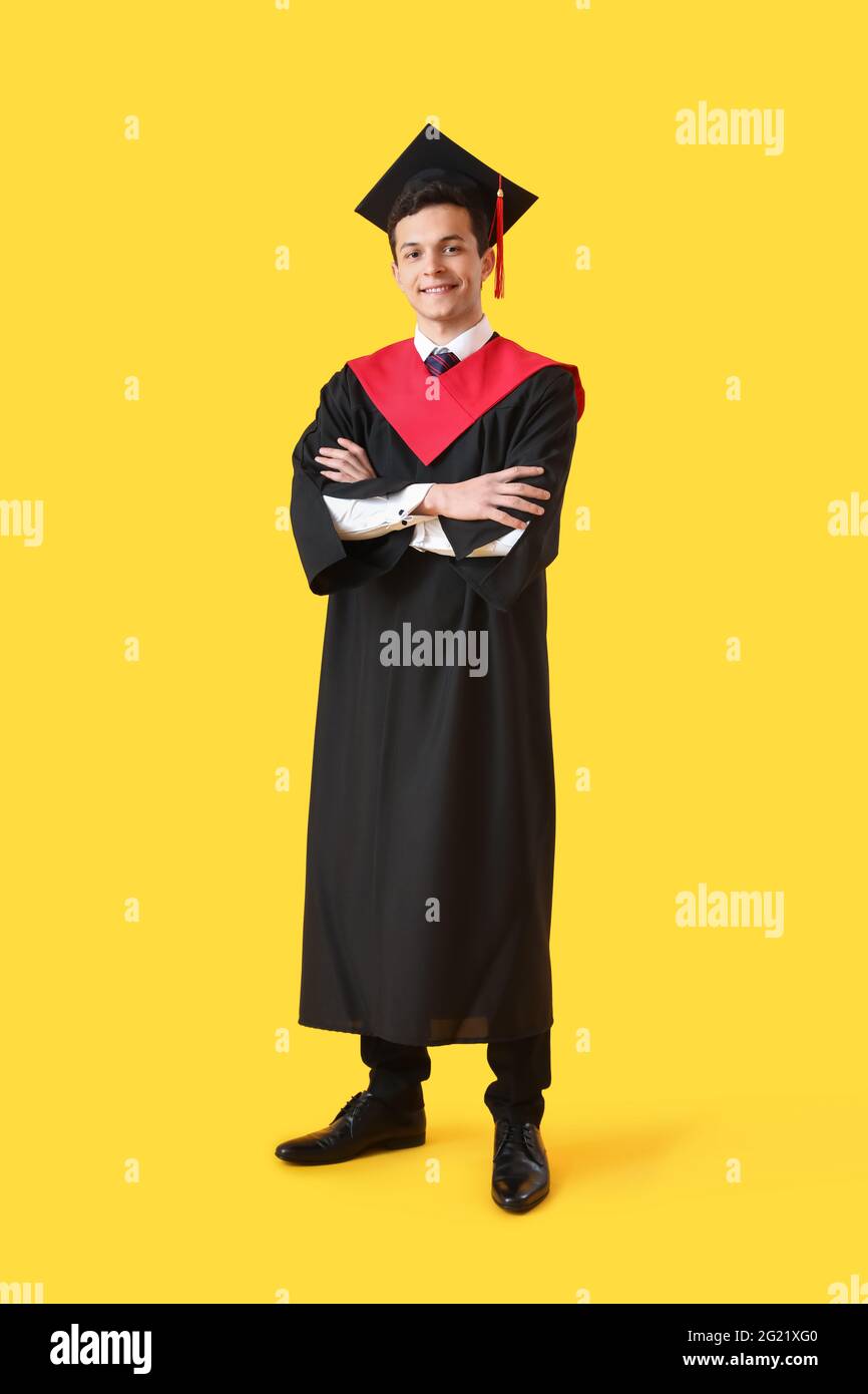 Male graduating student on color background Stock Photo - Alamy